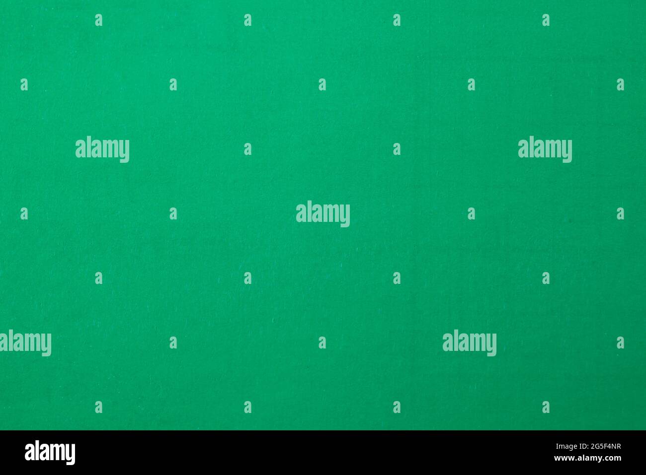 A smooth green wall background with a faint square grid pattern Stock ...