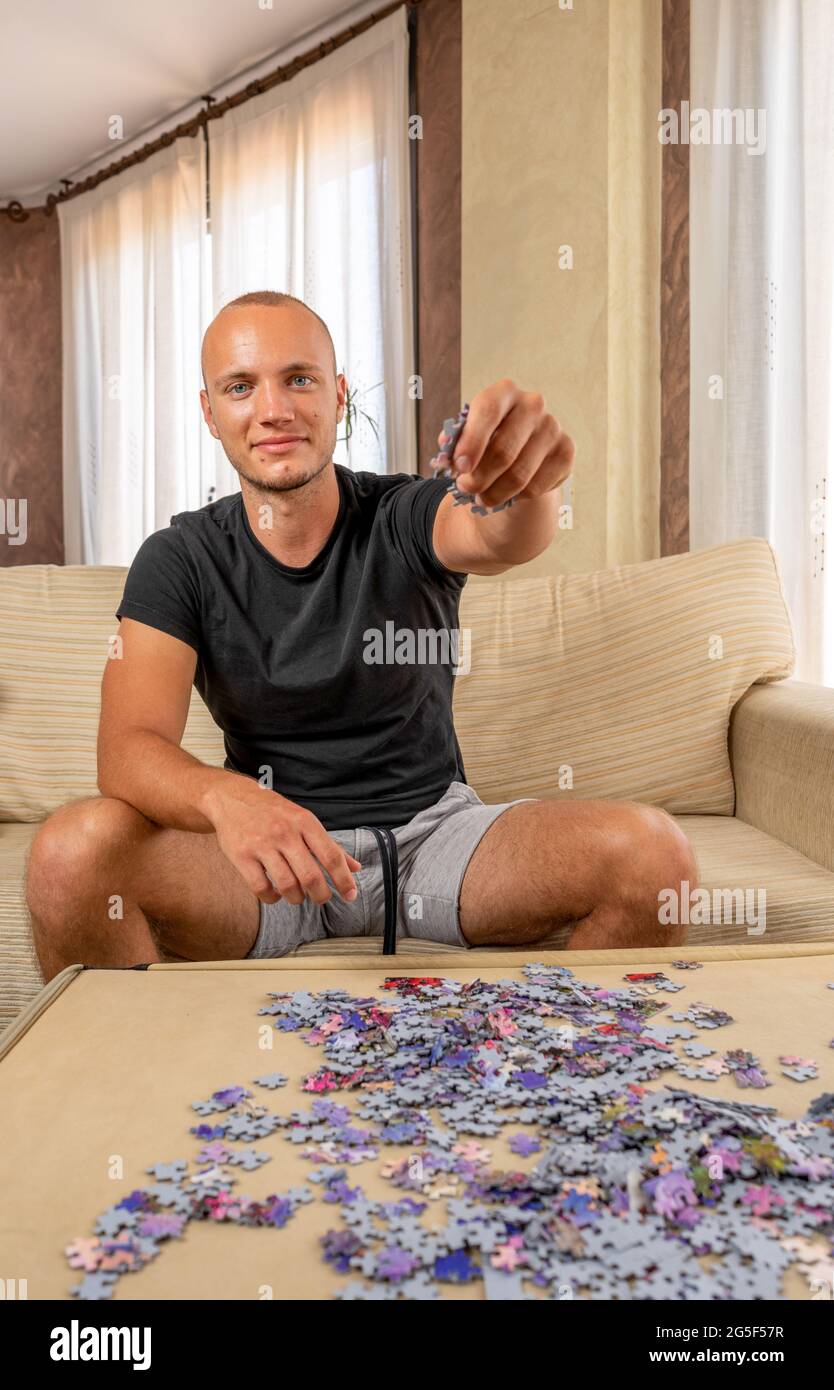 Person doing jigsaw hi-res stock photography and images - Alamy