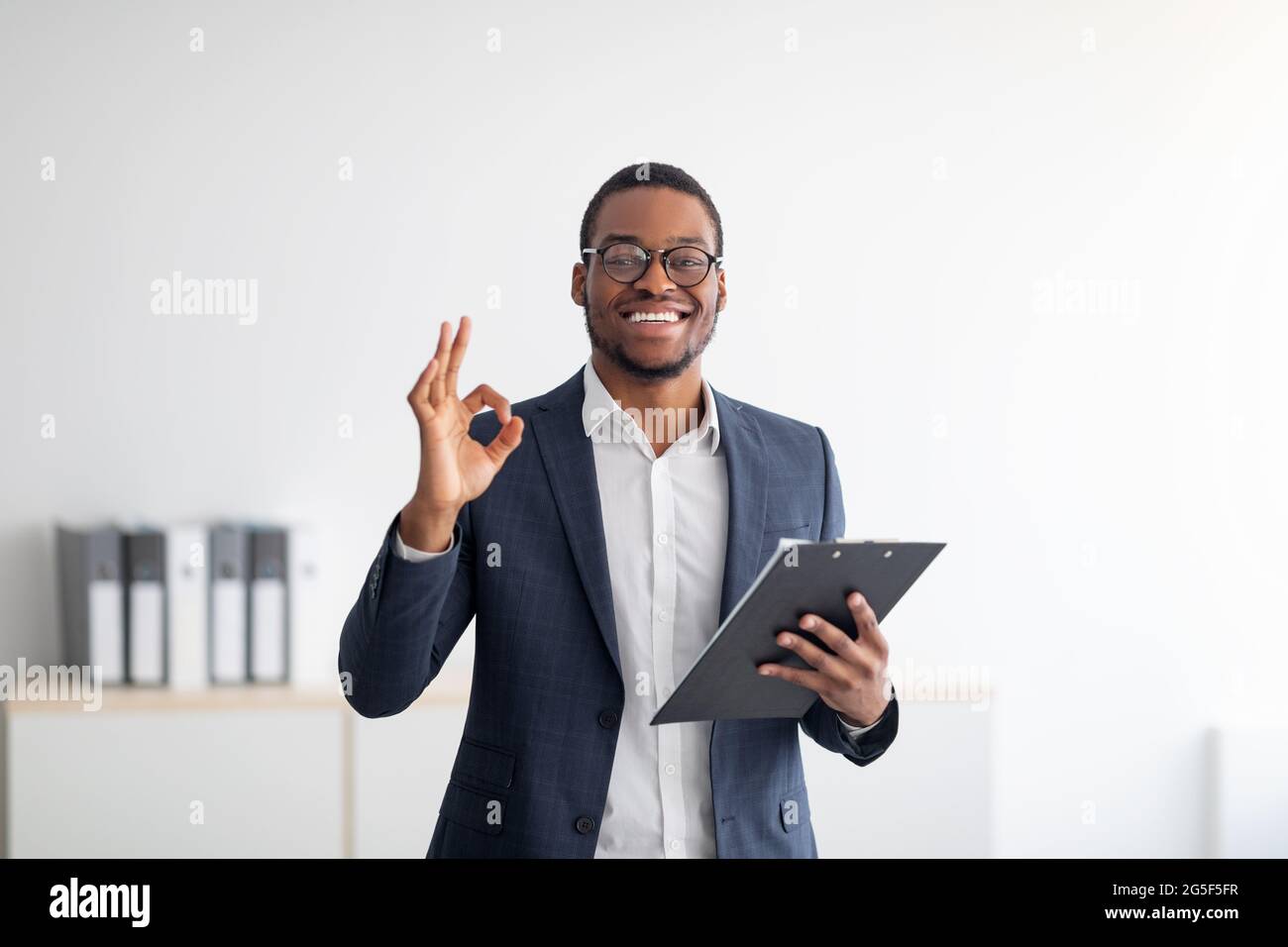 Portrait of cheerful black male psychologist showing okay gesture ...