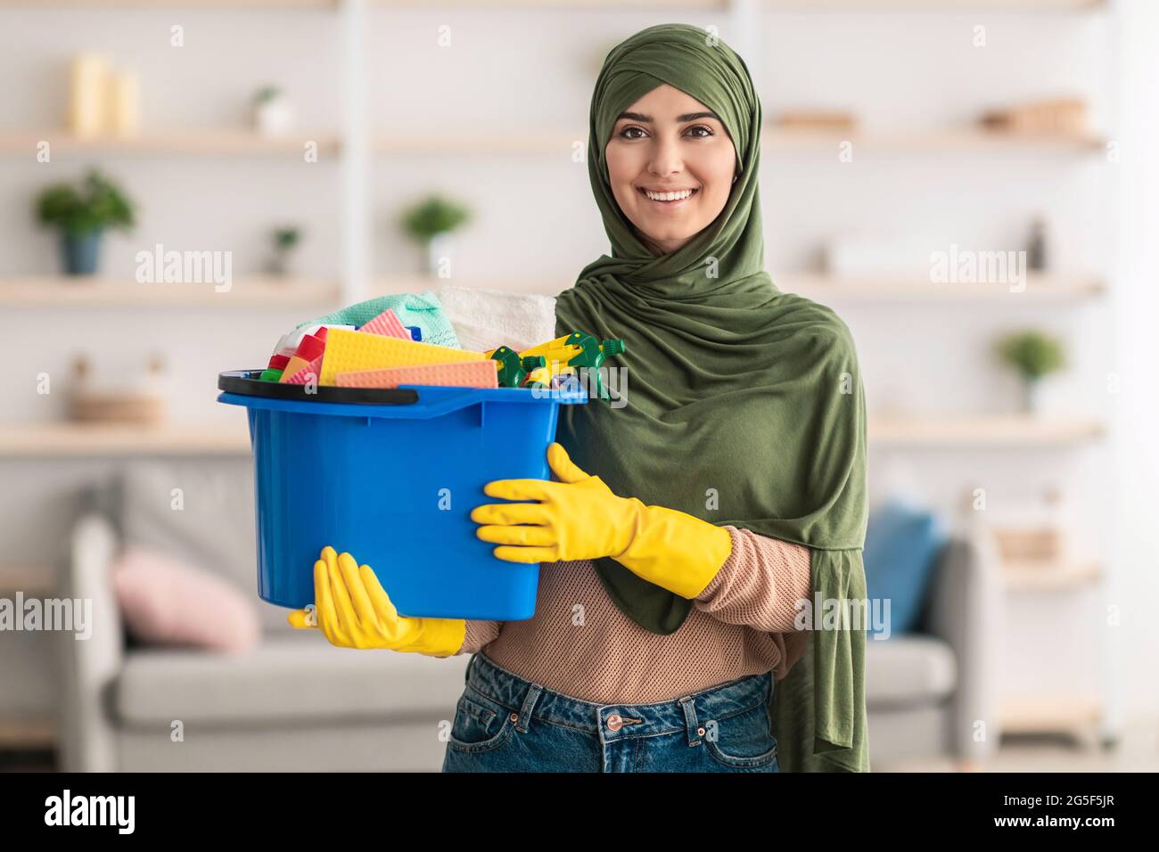 Domestic Chores Concept. Portrait of smiling islamic woman in hijab ...