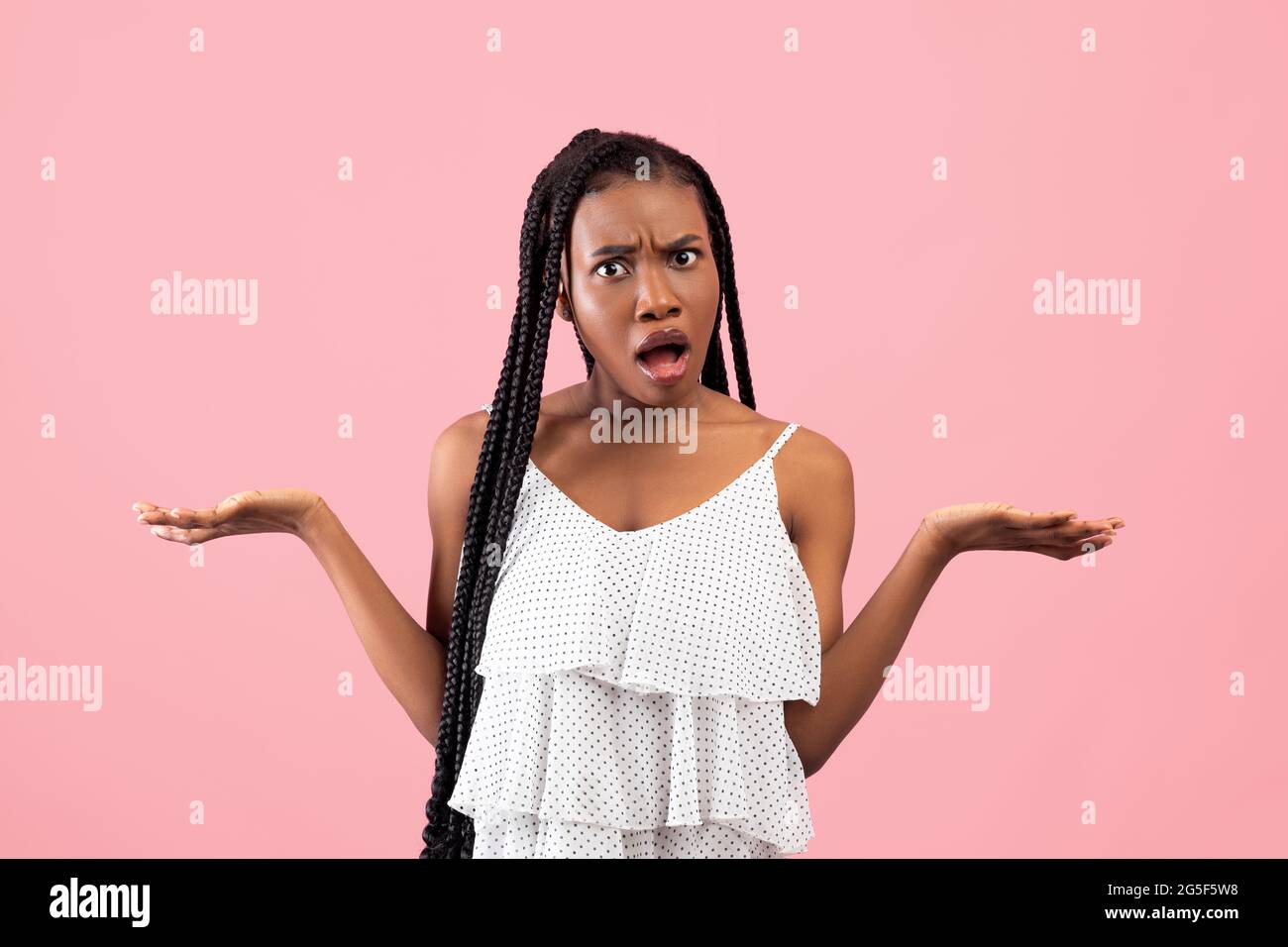 Irritated African American woman showing I DON'T KNOW gesture ...