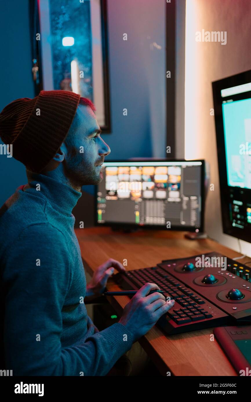 Attractive Male Video Editor Works with Footage or Video on His ...
