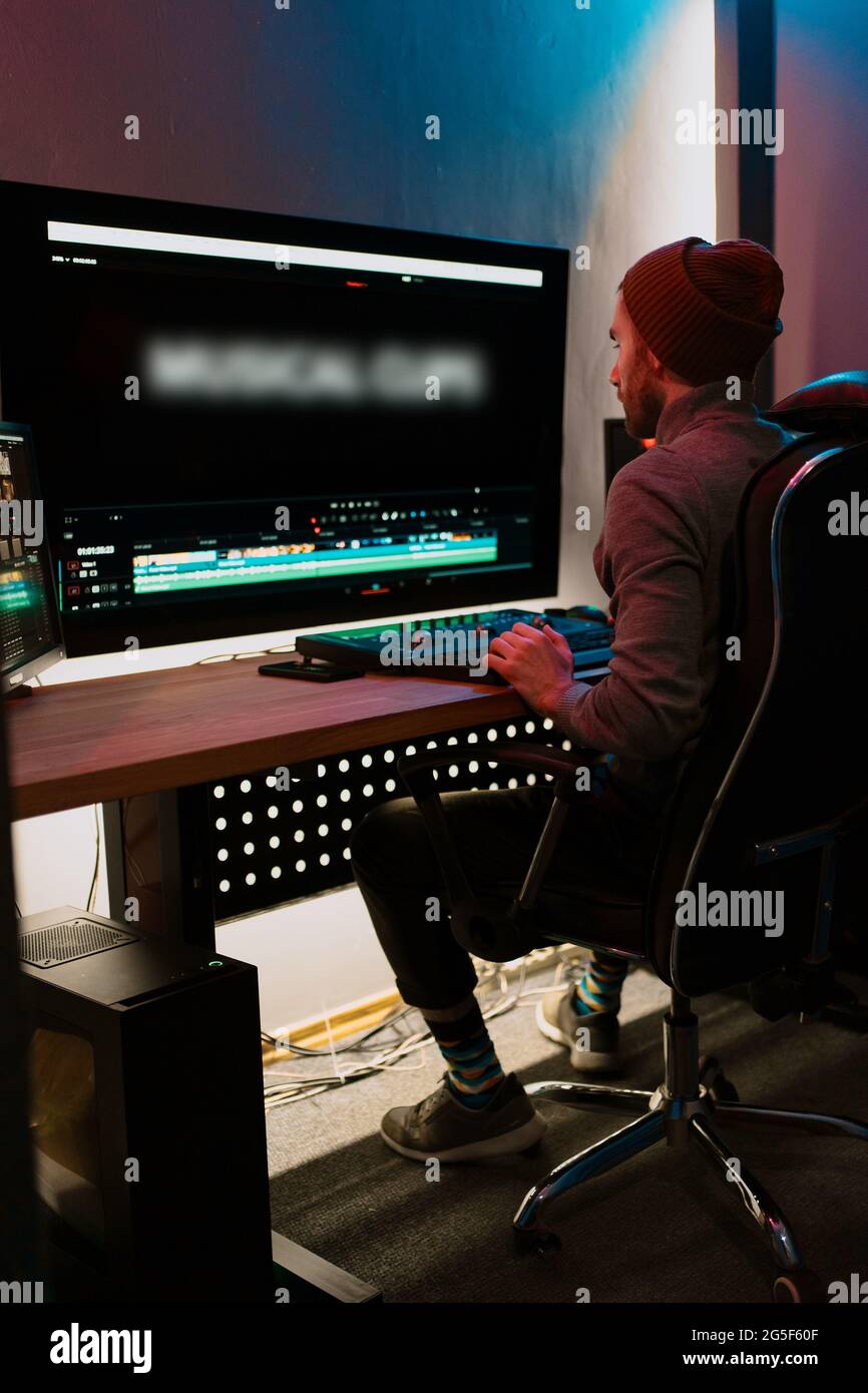 Attractive Male Video Editor Works with Footage or Video on His ...