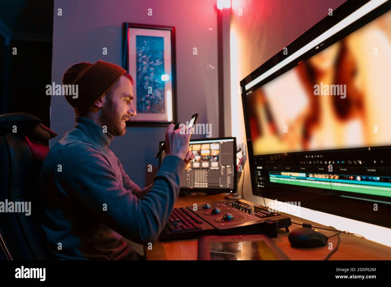 Attractive Male Video Editor Works with Footage or Video on His ...