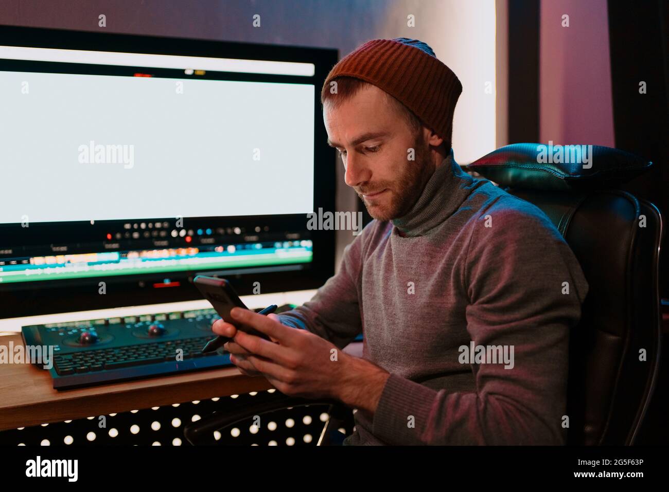 Attractive Male Video Editor Works with Footage or Video on His ...