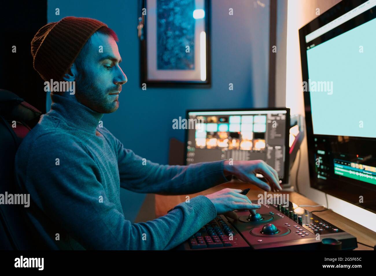 Attractive Male Video Editor Works with Footage or Video on His ...