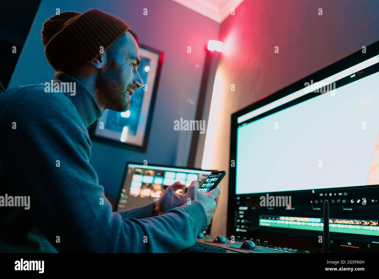 Attractive Male Video Editor Works with Footage or Video on His ...