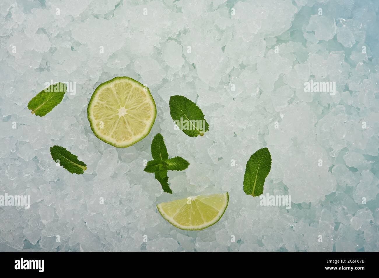 Close up fresh juicy green lime cut half and wedge slice and mint ...
