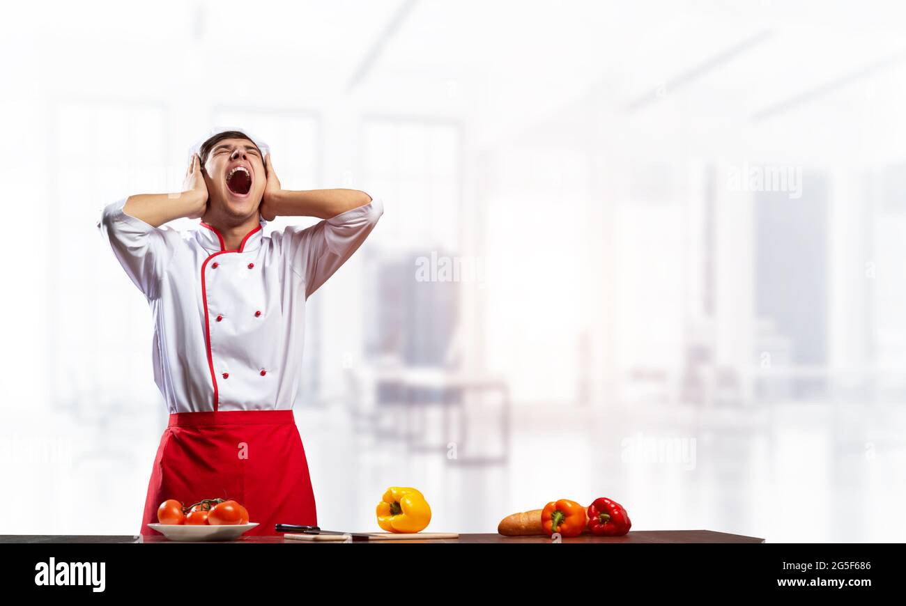 Young male chef screaming in shock and horror Stock Photo - Alamy