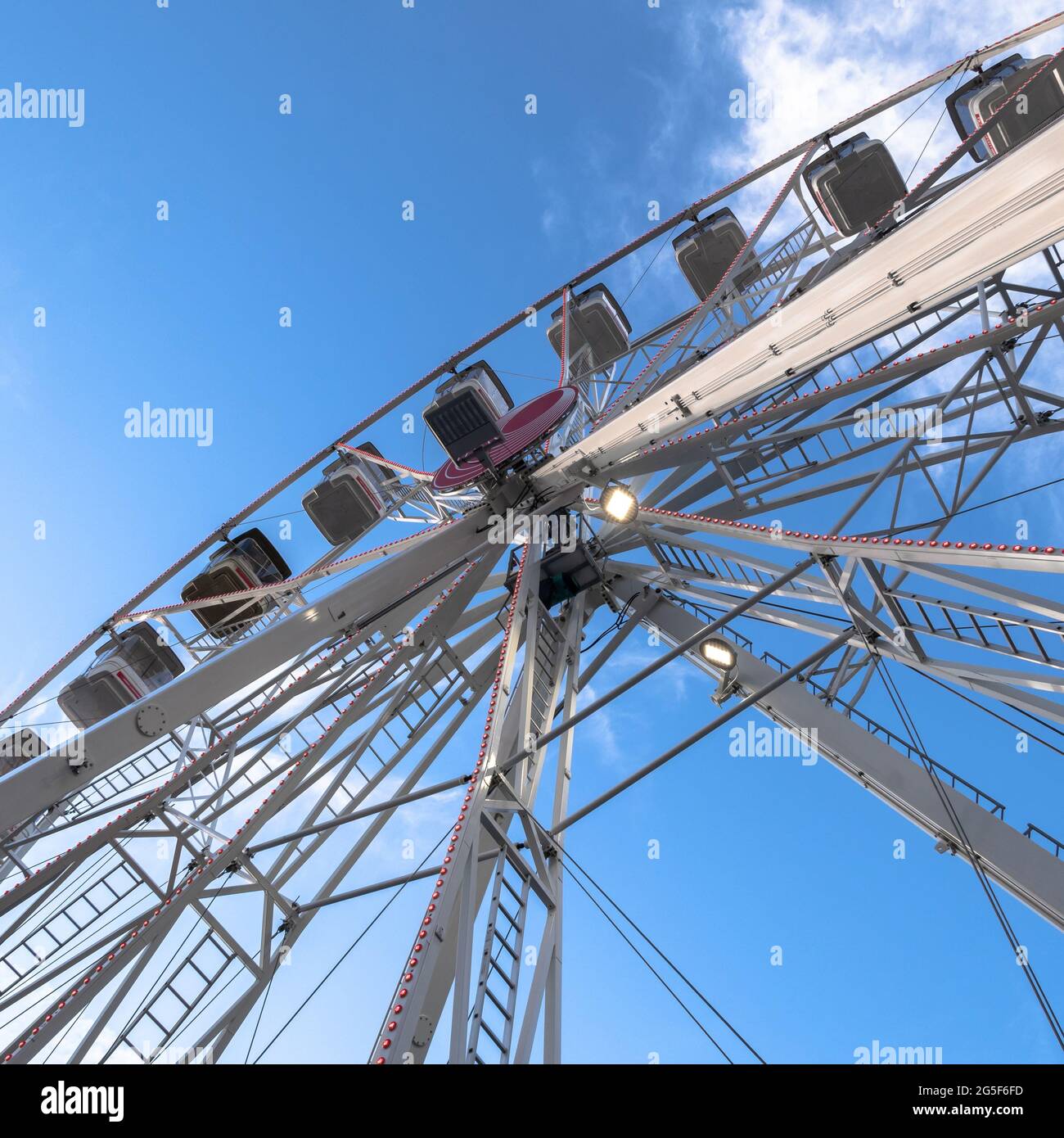 Amusement park. Ferris wheel on cloudy sky background. Bottom view ...
