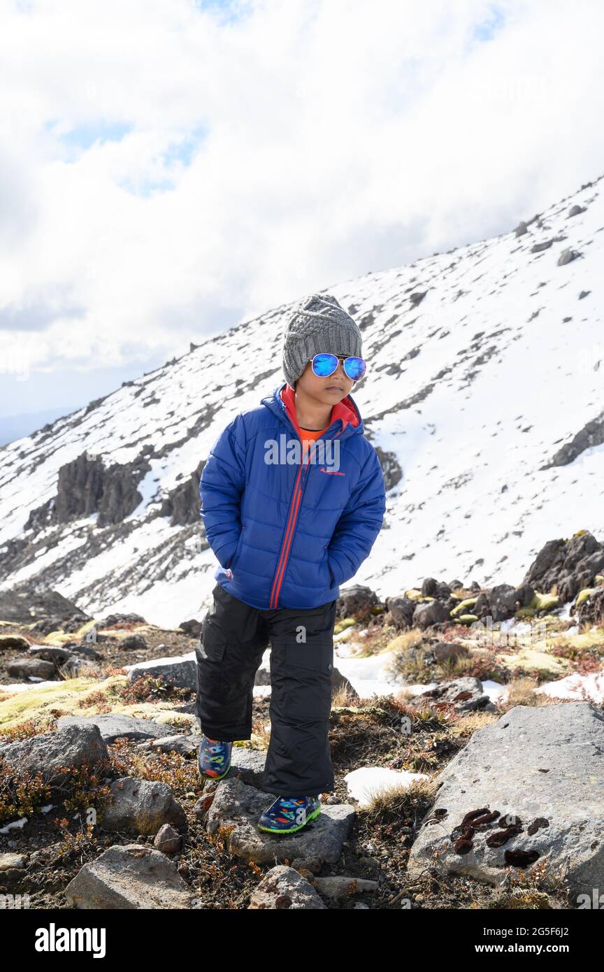 Smart boy in snow with jacket and coolers Stock Photo - Alamy