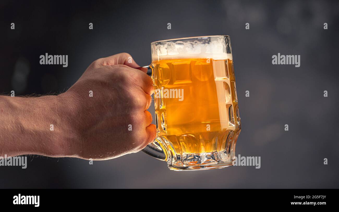 Hand holding glass light beer hi-res stock photography and images - Alamy