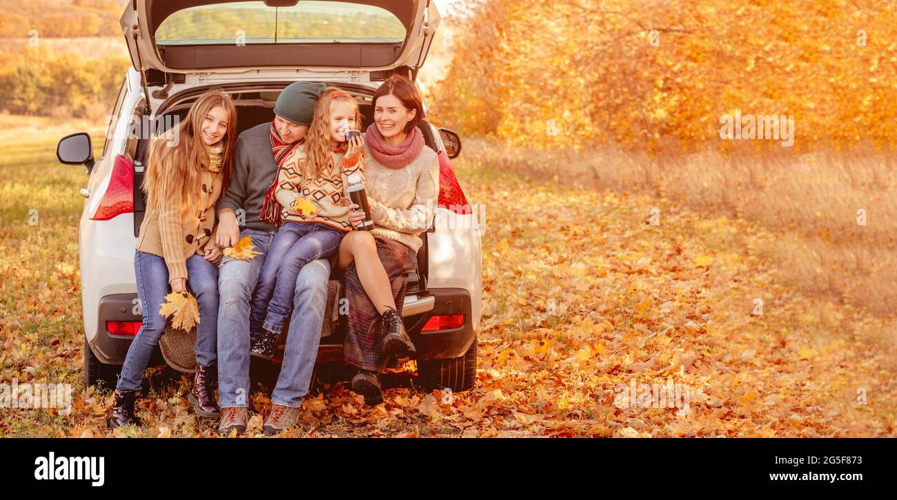 Family resting in car trunk Stock Photo - Alamy
