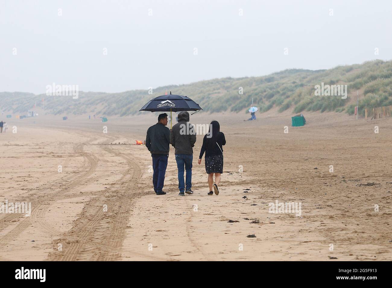 Umbrellas beach in rain hi-res stock photography and images - Alamy