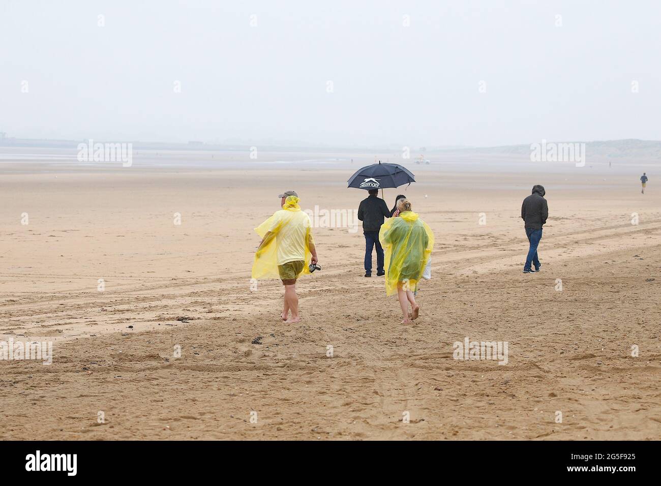 Umbrella beach rain uk hi-res stock photography and images - Alamy