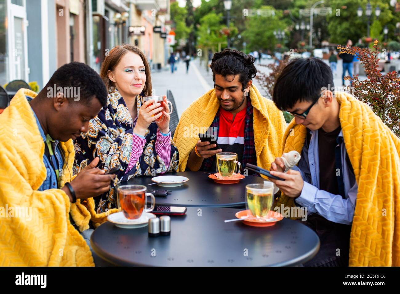Multiracial group of friends having lunch together Stock Photo - Alamy