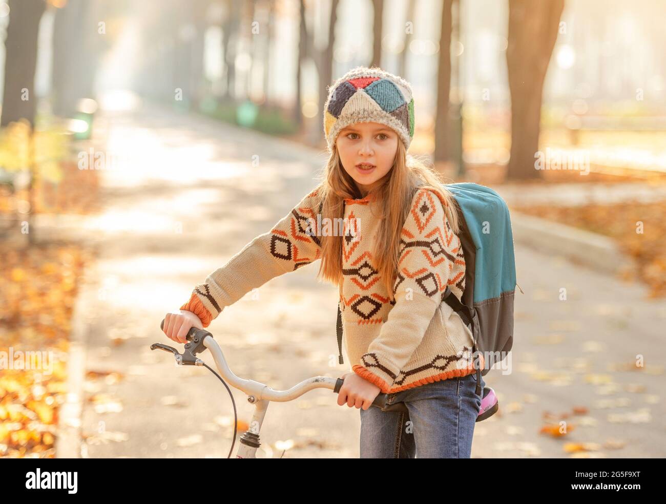 Bicycle girl riding to school Stock Photo - Alamy