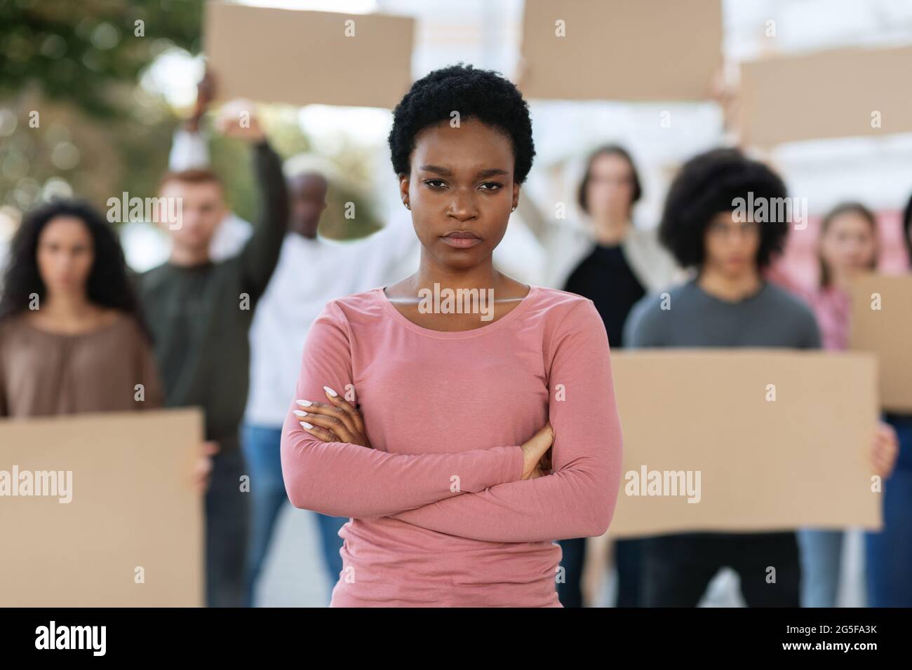 Angry black lady leading multiracial group of protestors, selective ...