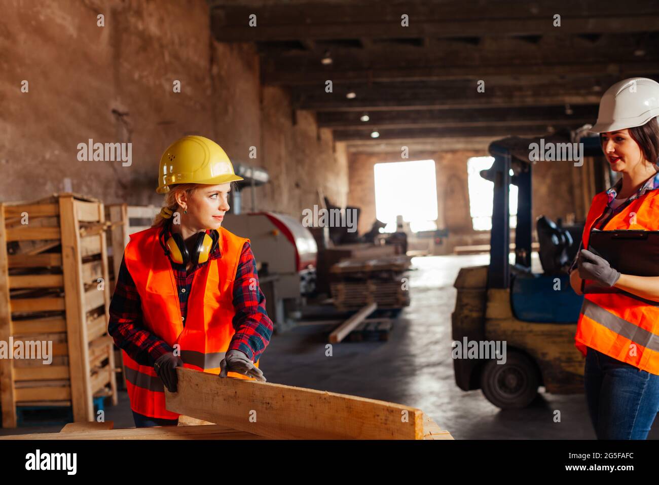 The young women in uniform working in a factory Stock Photo - Alamy