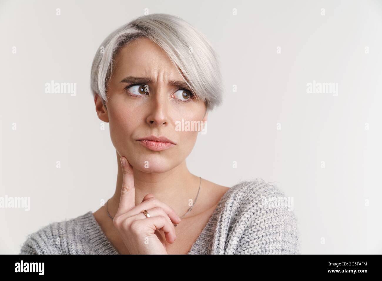 Puzzled beautiful silver girl posing and looking aside isolated over ...