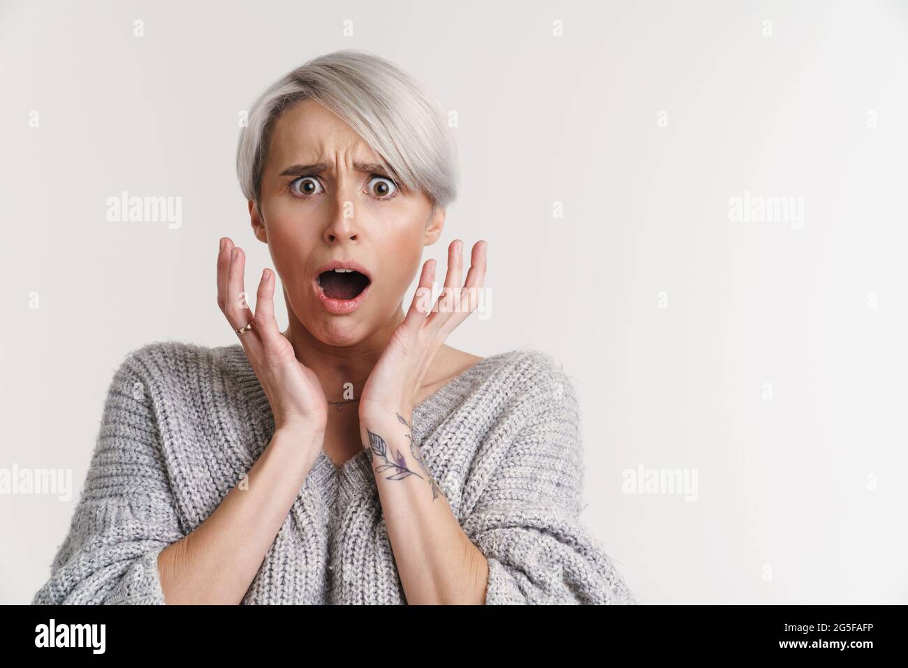 Scared beautiful silver girl expressing surprise at camera isolated ...