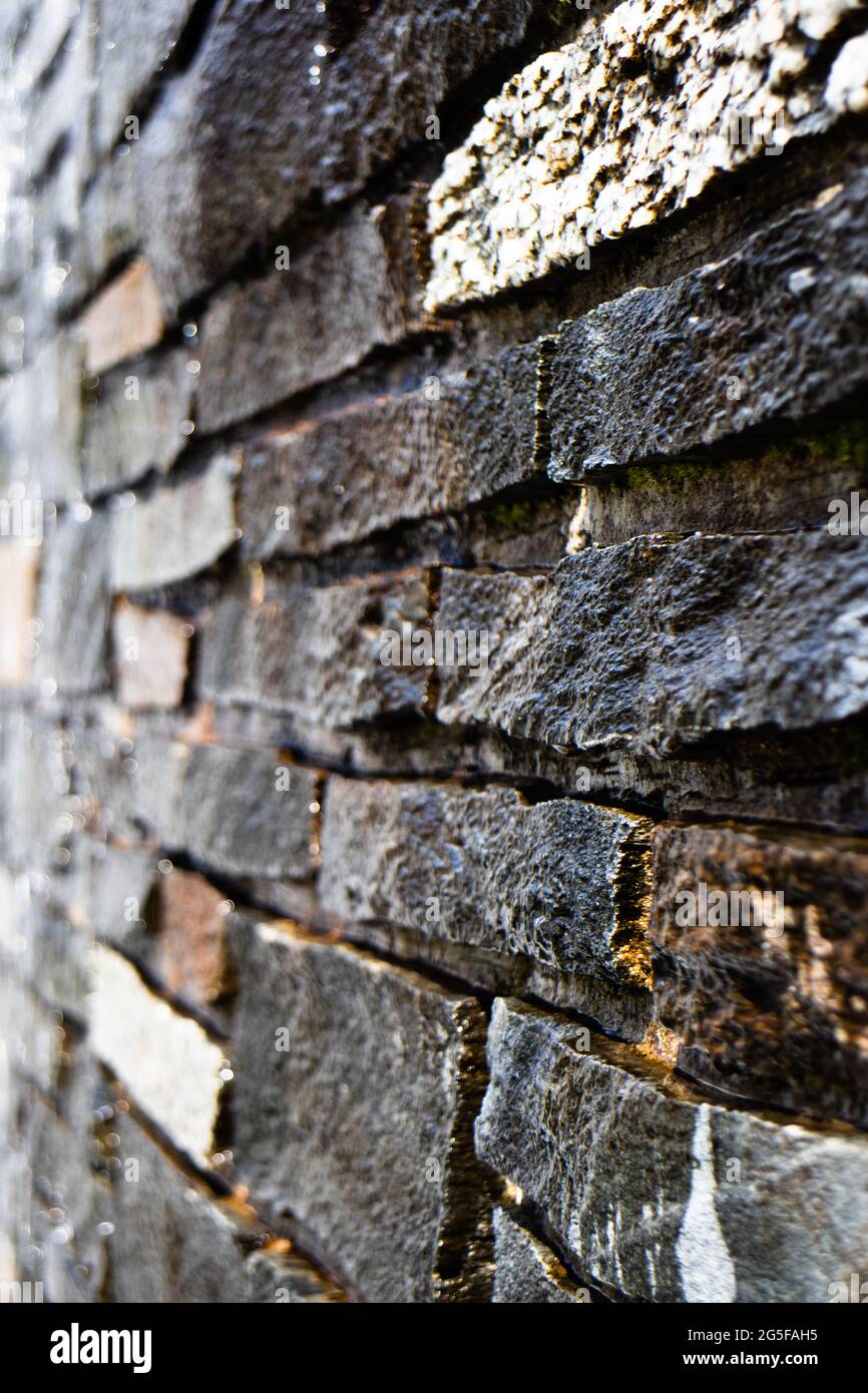 Stone wall close up with waterfall in background Stock Photo - Alamy