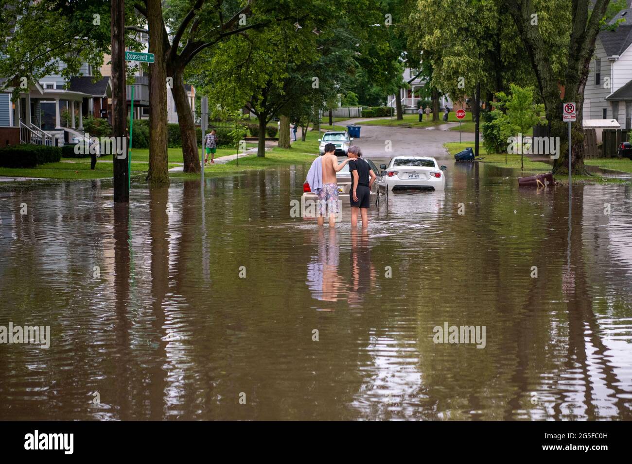 A street in Ann Arbor, MI experiences the aftermath of severe flooding ...