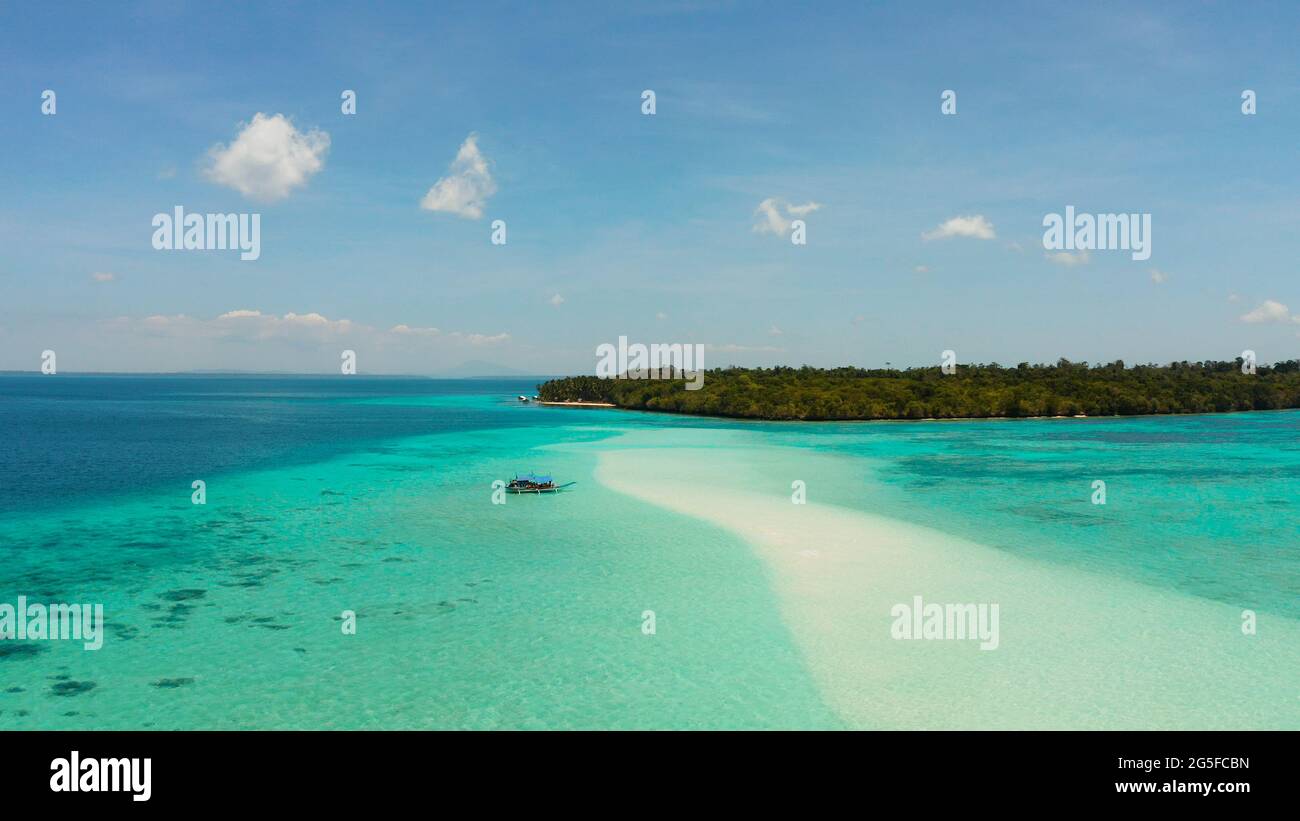 Sand bar and tropical island in the clear turquoise waters of the ...