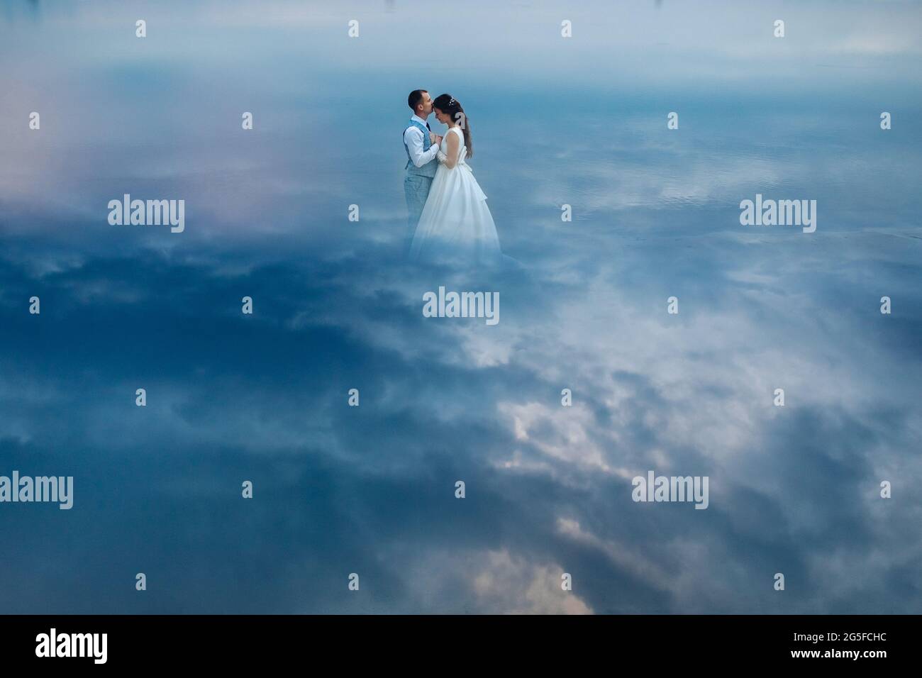 Beautiful newlywed couple in sky Stock Photo - Alamy