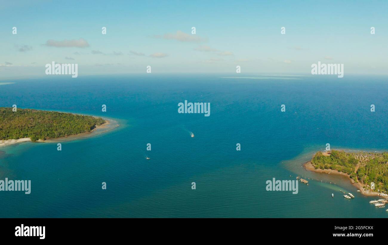Tropical island Balabac covered with green rain forest against the blue ...