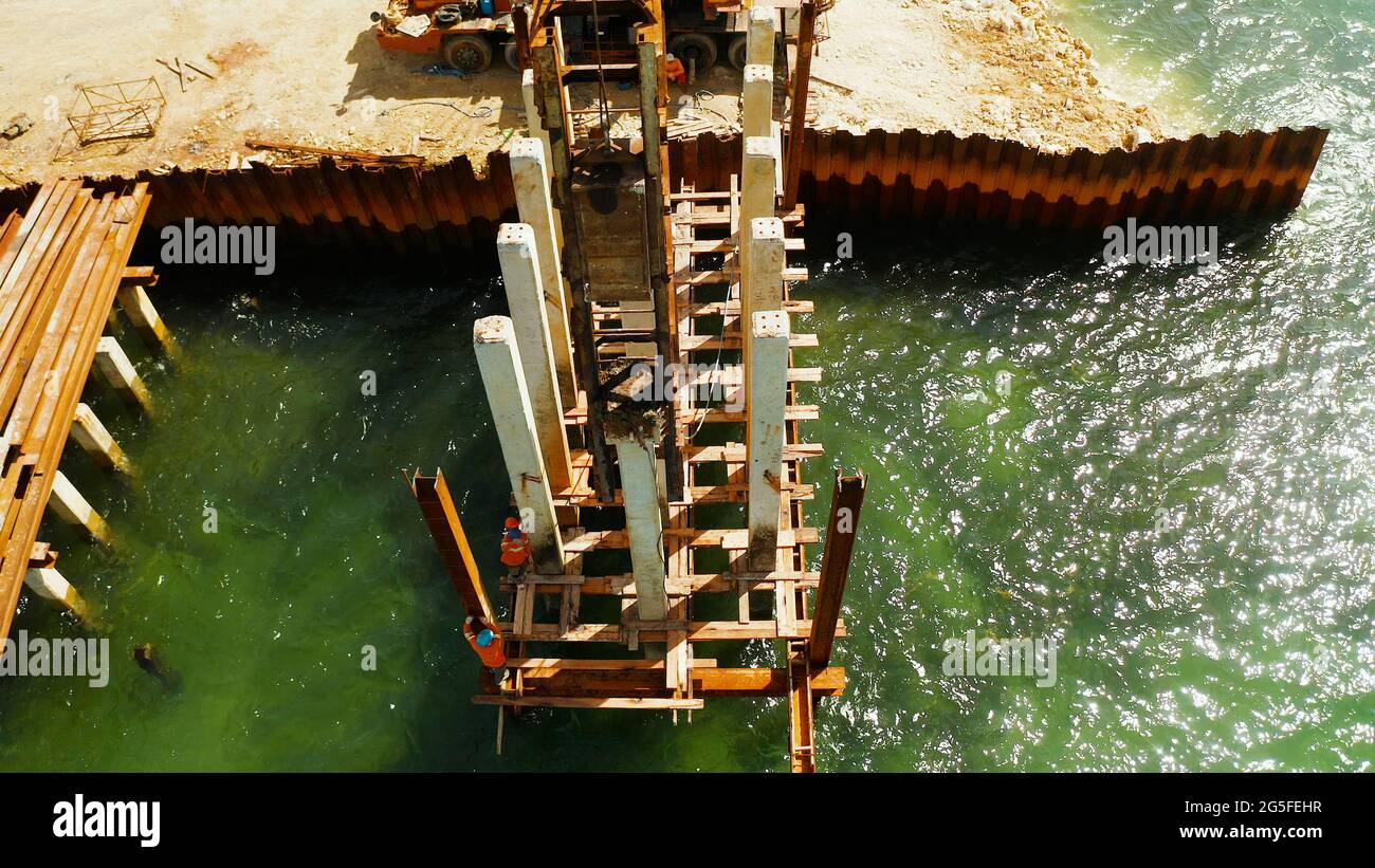 Pile hammer working on construction site. Bridge under construction ...