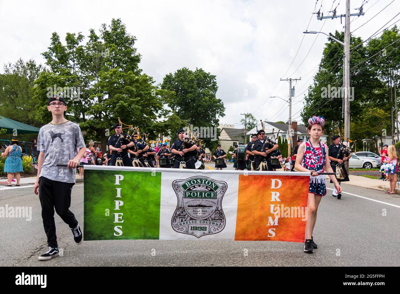 Kids holding a sign announcing the Boston Police Gaelic Column at the ...