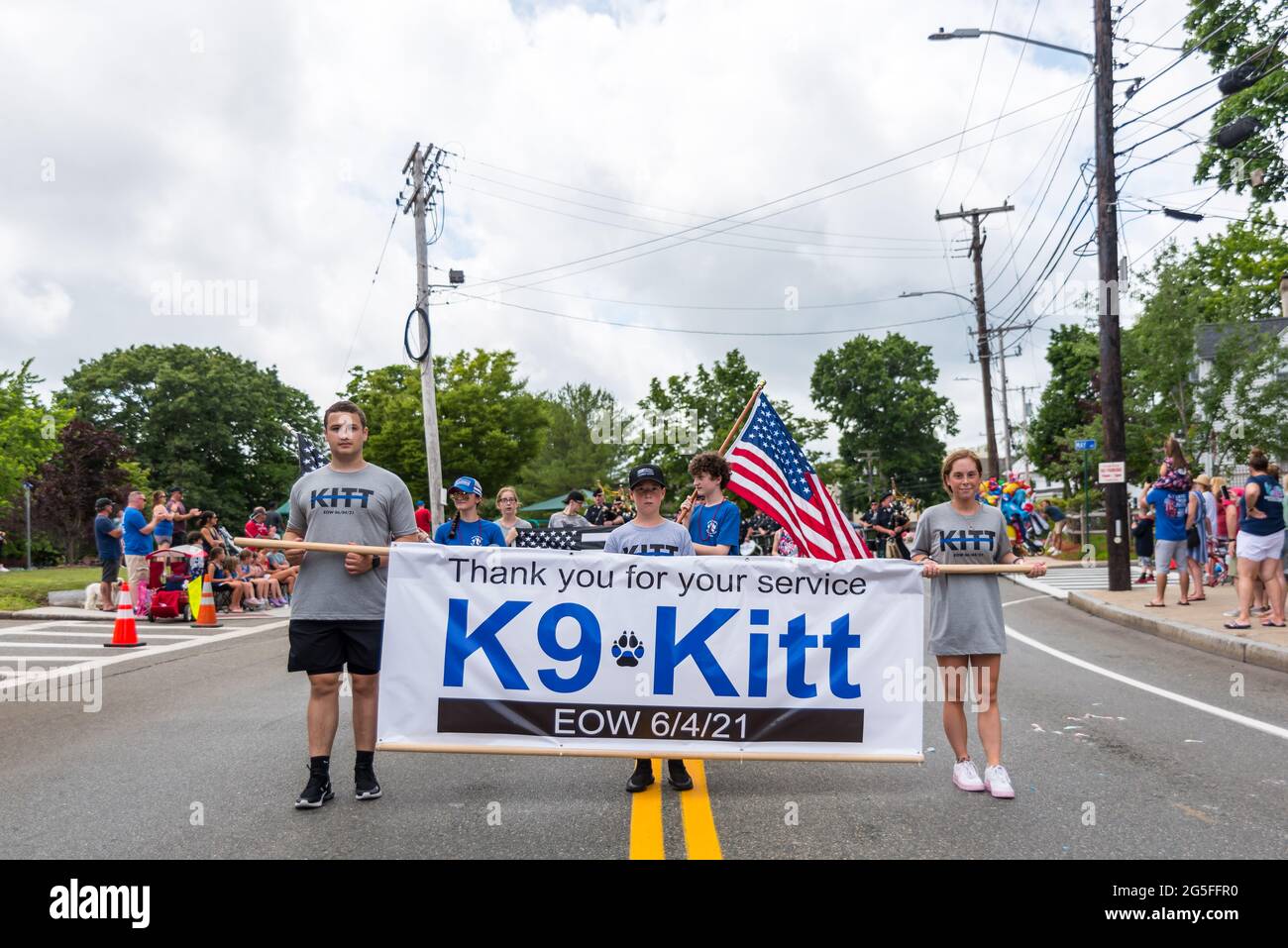 Children holding a sign honoring Braintree police K9 Kitt at the 2021 ...
