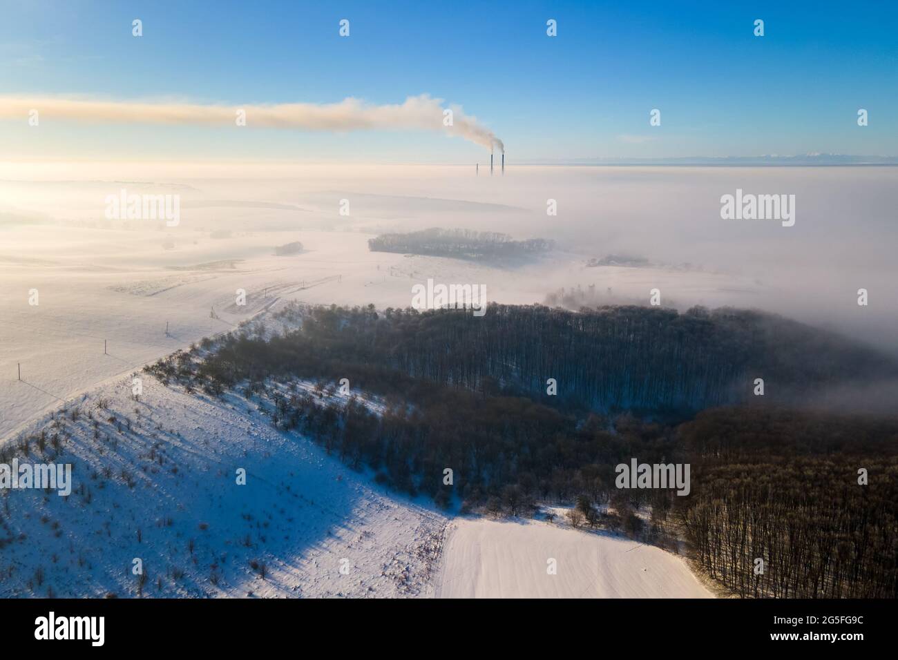 Aerial view of winter landscape with foggy countryside and distant ...