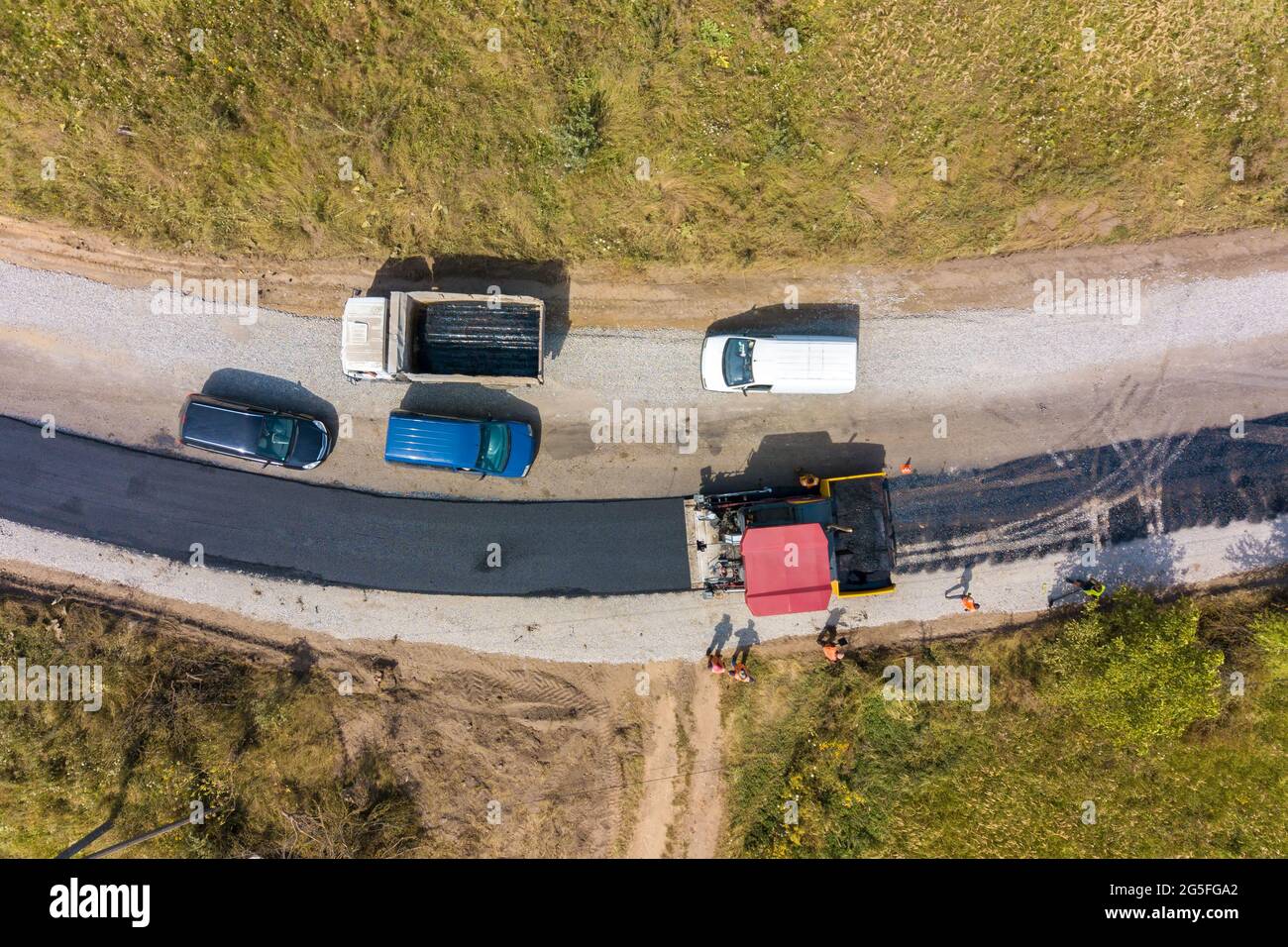 Aerial view of new road construction with asphalt laying machinery at ...