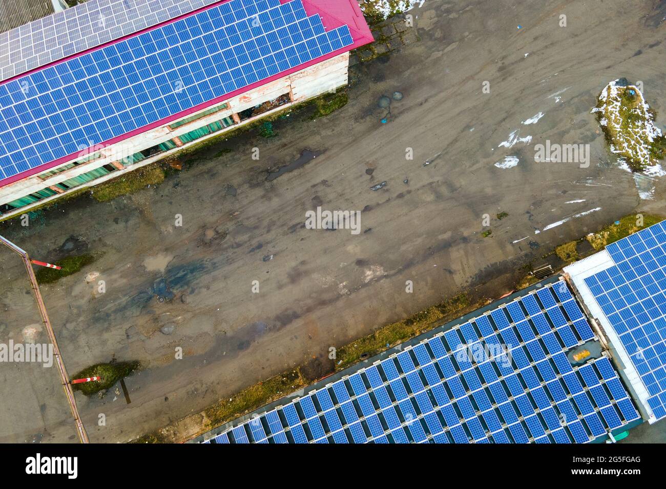 Blue photovoltaic solar panels mounted on industrial building roof for ...