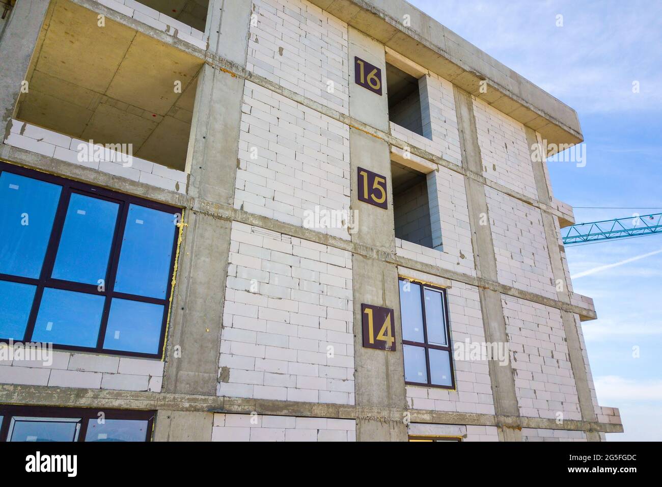 Aerial view of high residential apartment building with storey numbers ...