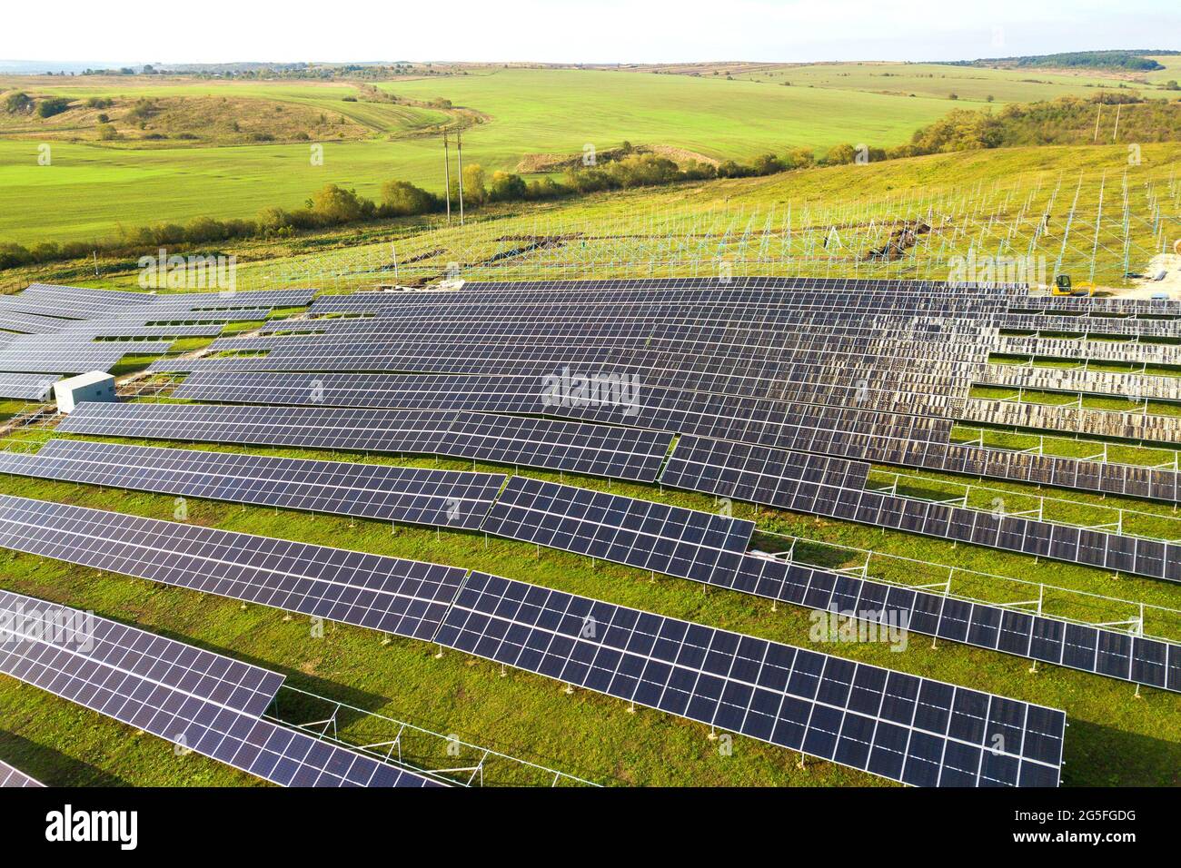 Aerial view of solar power plant under construction on green field ...