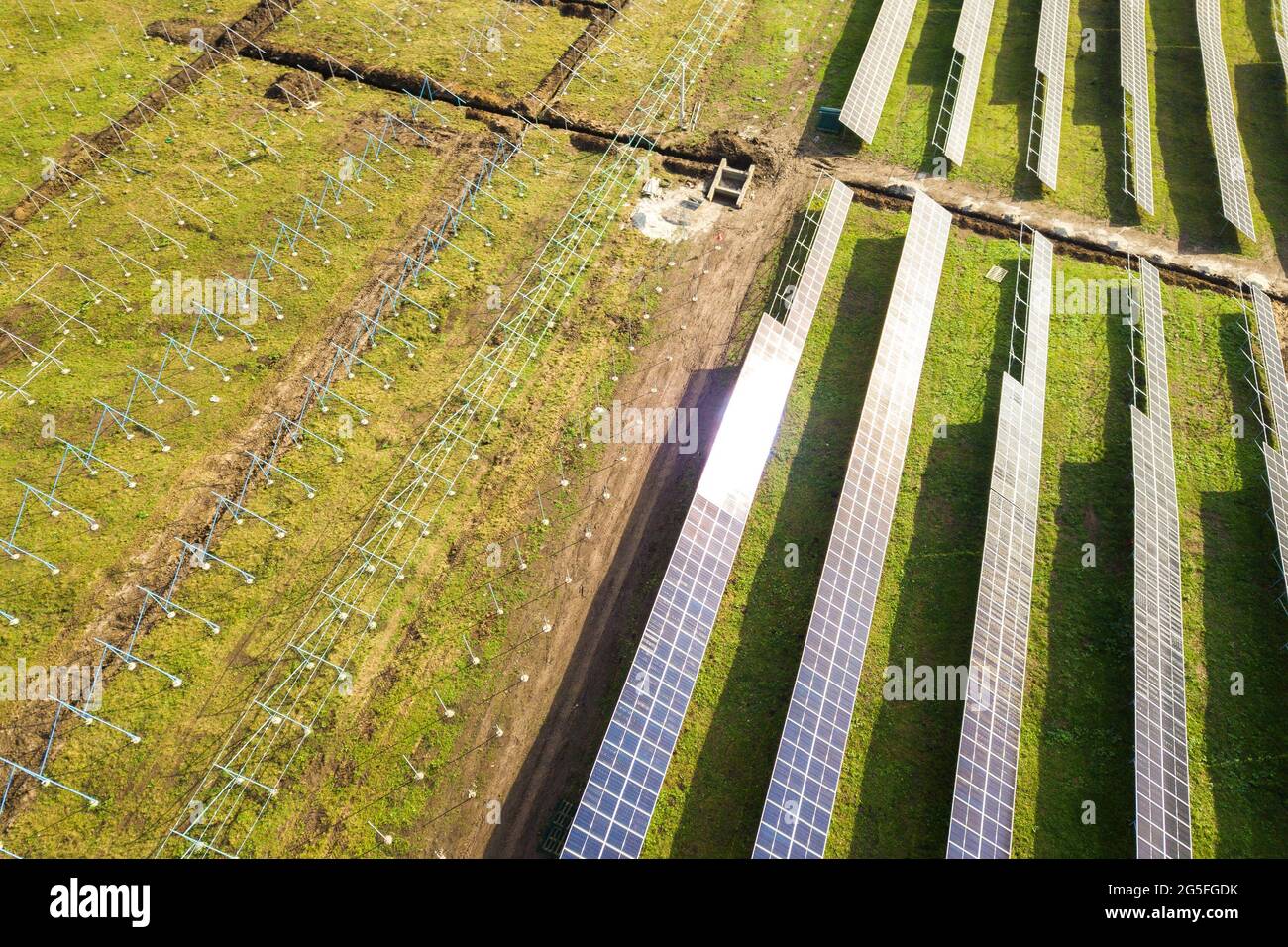 Aerial view of solar power plant under construction on green field ...