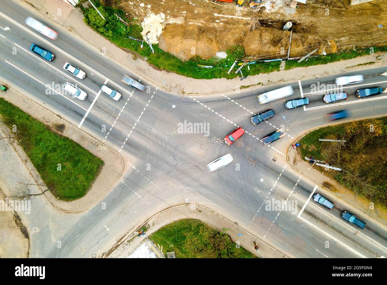 Top down aerial view of busy street intersection with moving cars ...