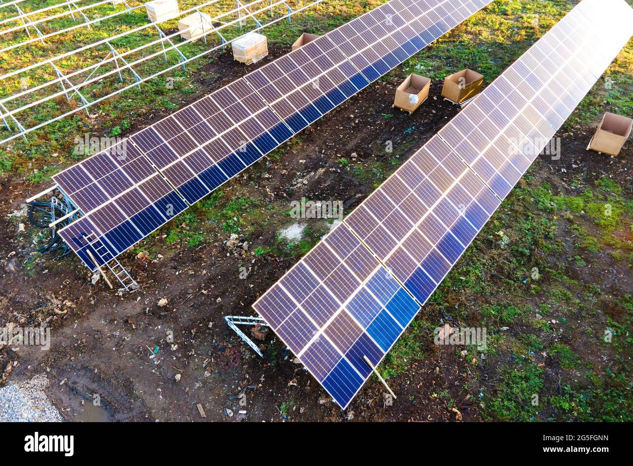 Aerial view of solar power plant under construction on green field ...