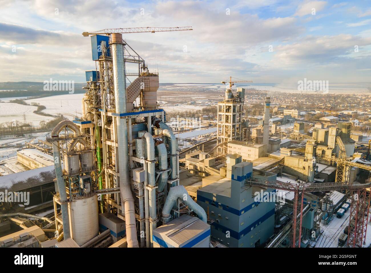 Aerial view of cement plant with high factory structure and tower crane ...