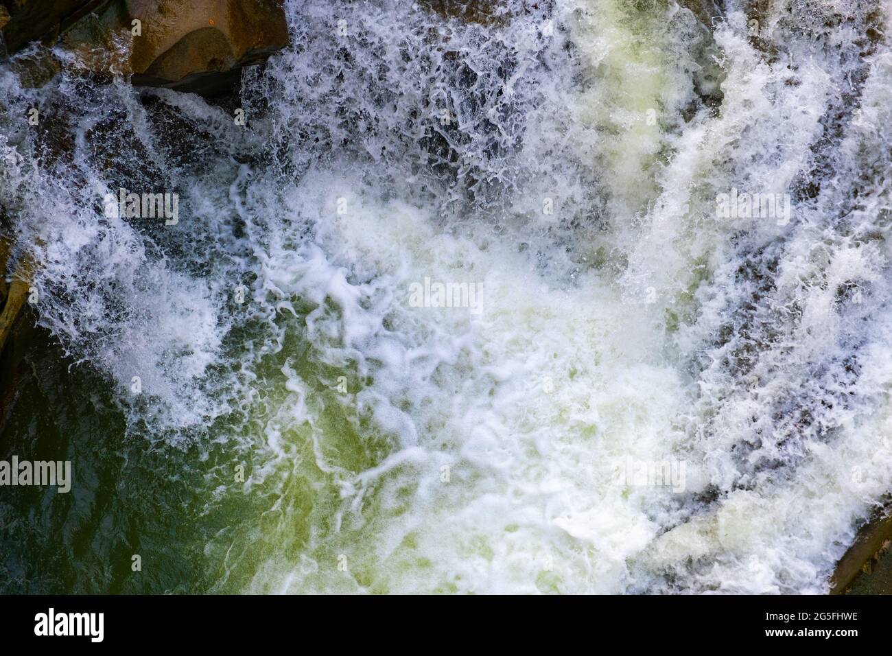 Aerial view of river waterfall with clear turquoise water falling down ...