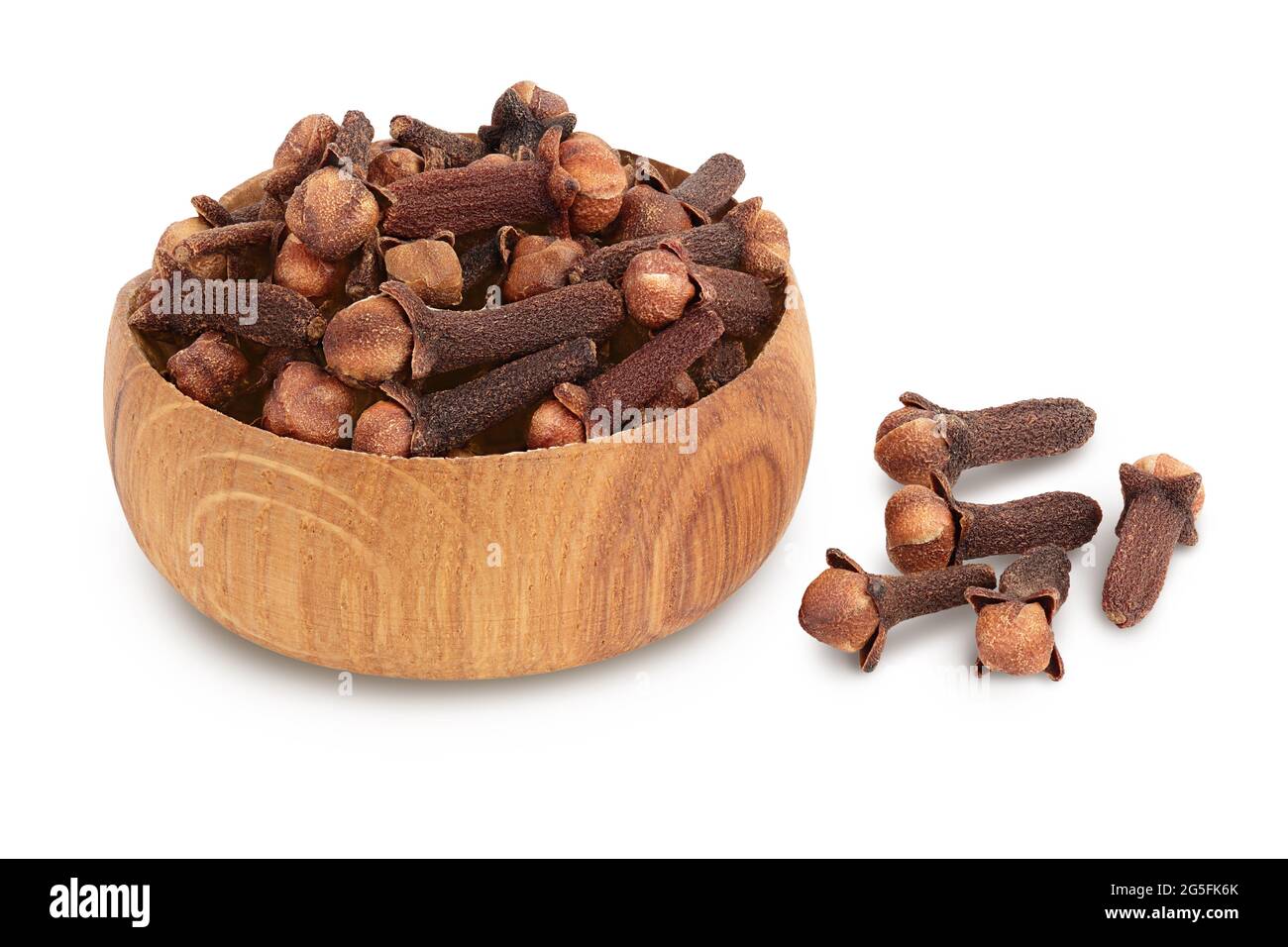 Dry spice cloves in wooden bowl isolated on white background with ...