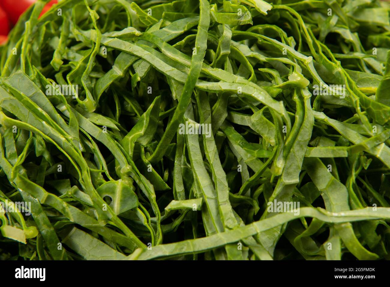 raw cabbage leaf cut and ready to saute on closeup view Stock Photo - Alamy