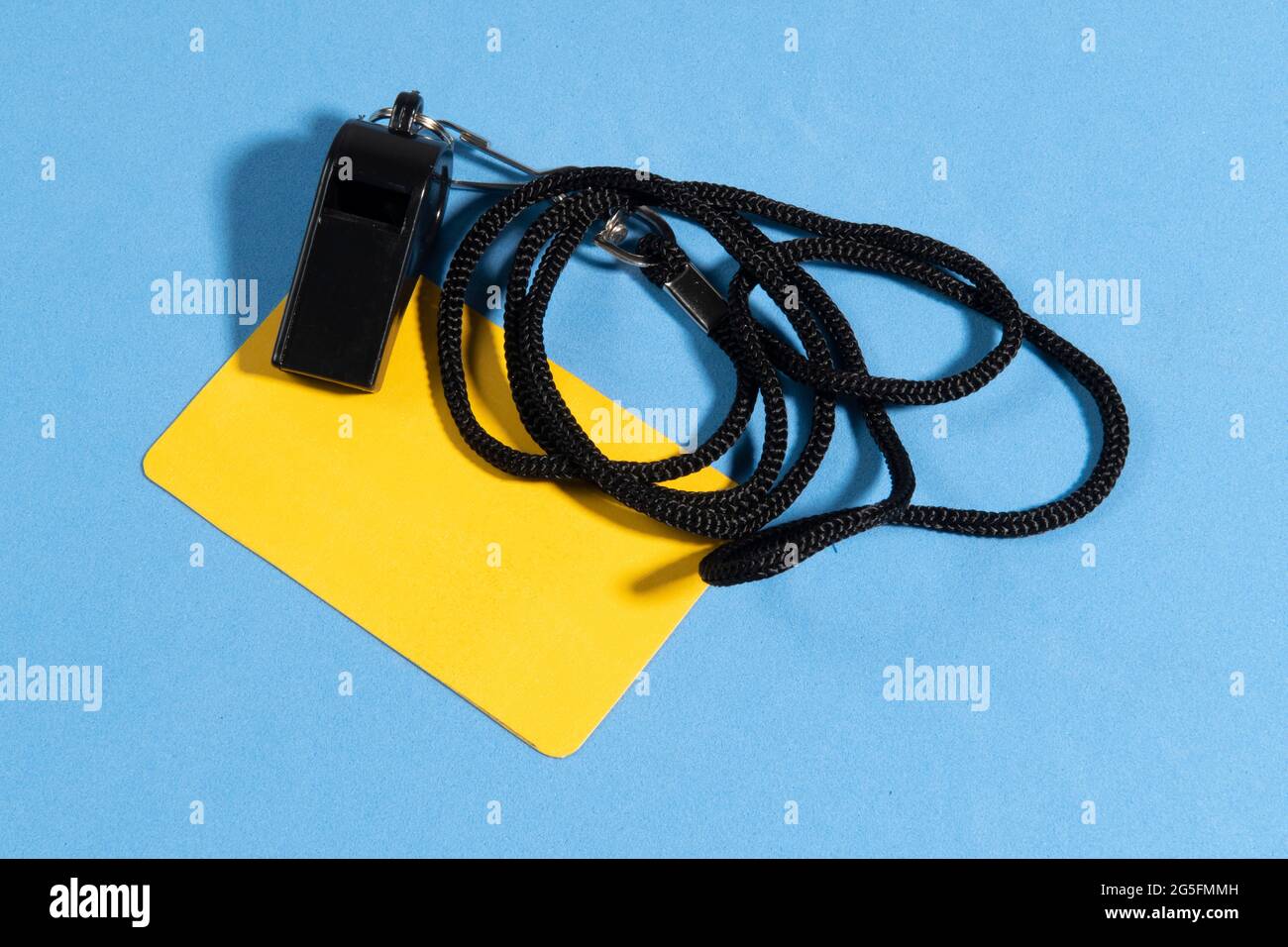 yellow card and referee whistle with space for text in a blue ...