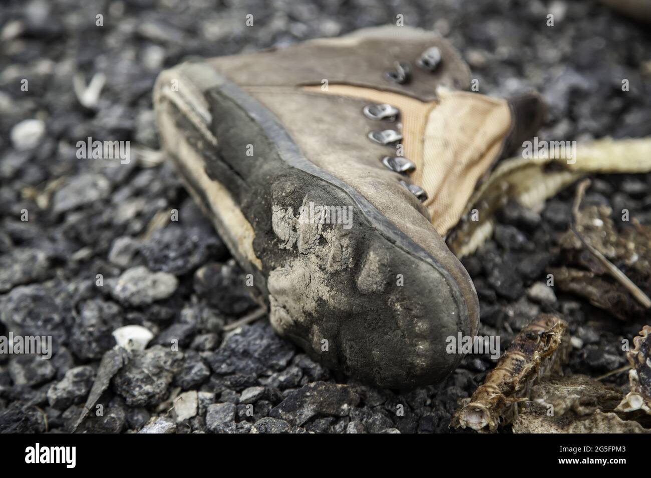Detail of broken and damaged footwear in the trash Stock Photo - Alamy