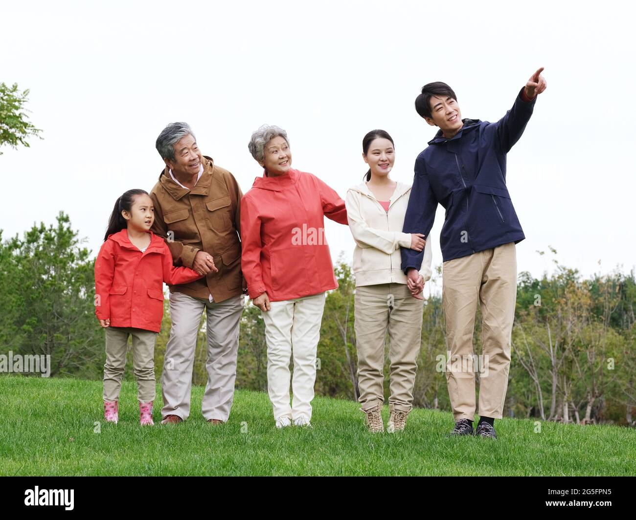 Happy family of five looking at the scenery in the park high quality ...