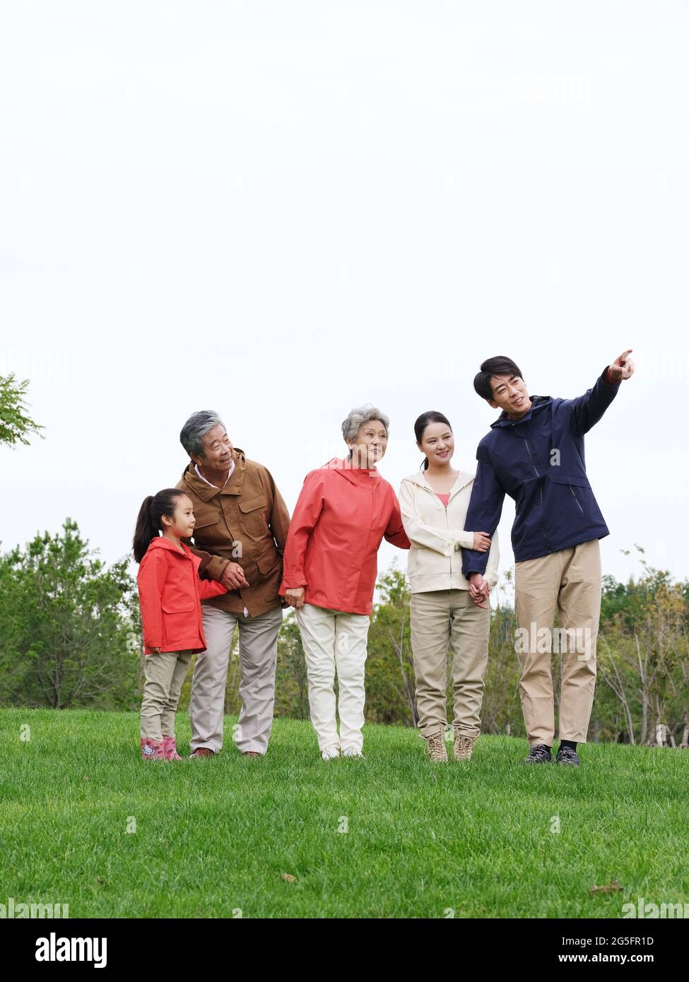 Happy family of five looking at the scenery in the park high quality ...