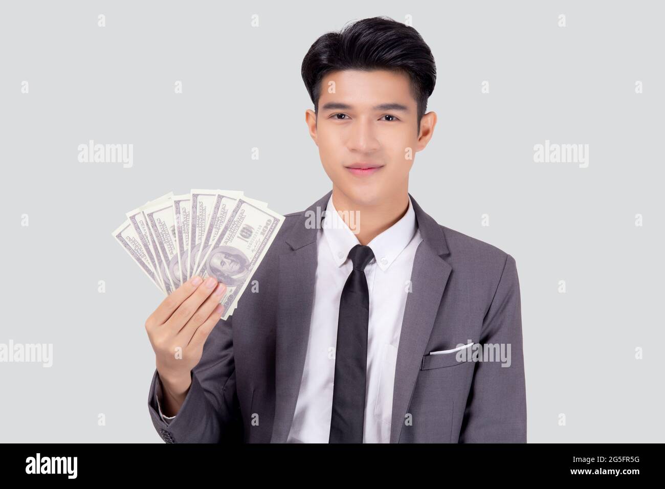 Young asian business man holding money dollar isolated on white ...
